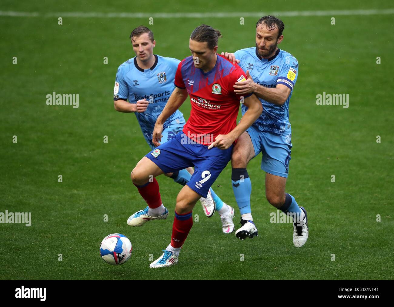 Blackburn Rovers' Sam Gallagher (centre) battles for the ball with ...