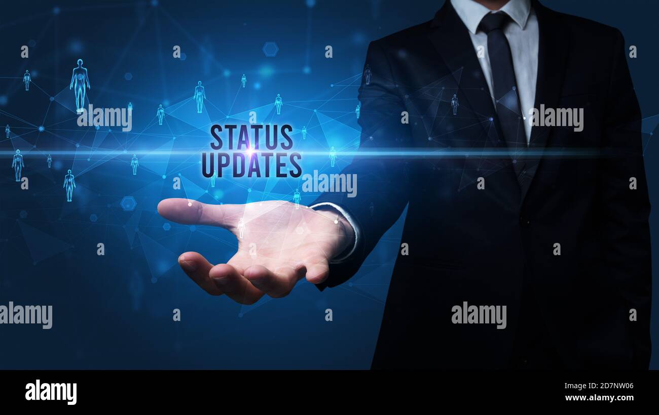 Elegant hand holding STATUS UPDATES inscription, social networking ...
