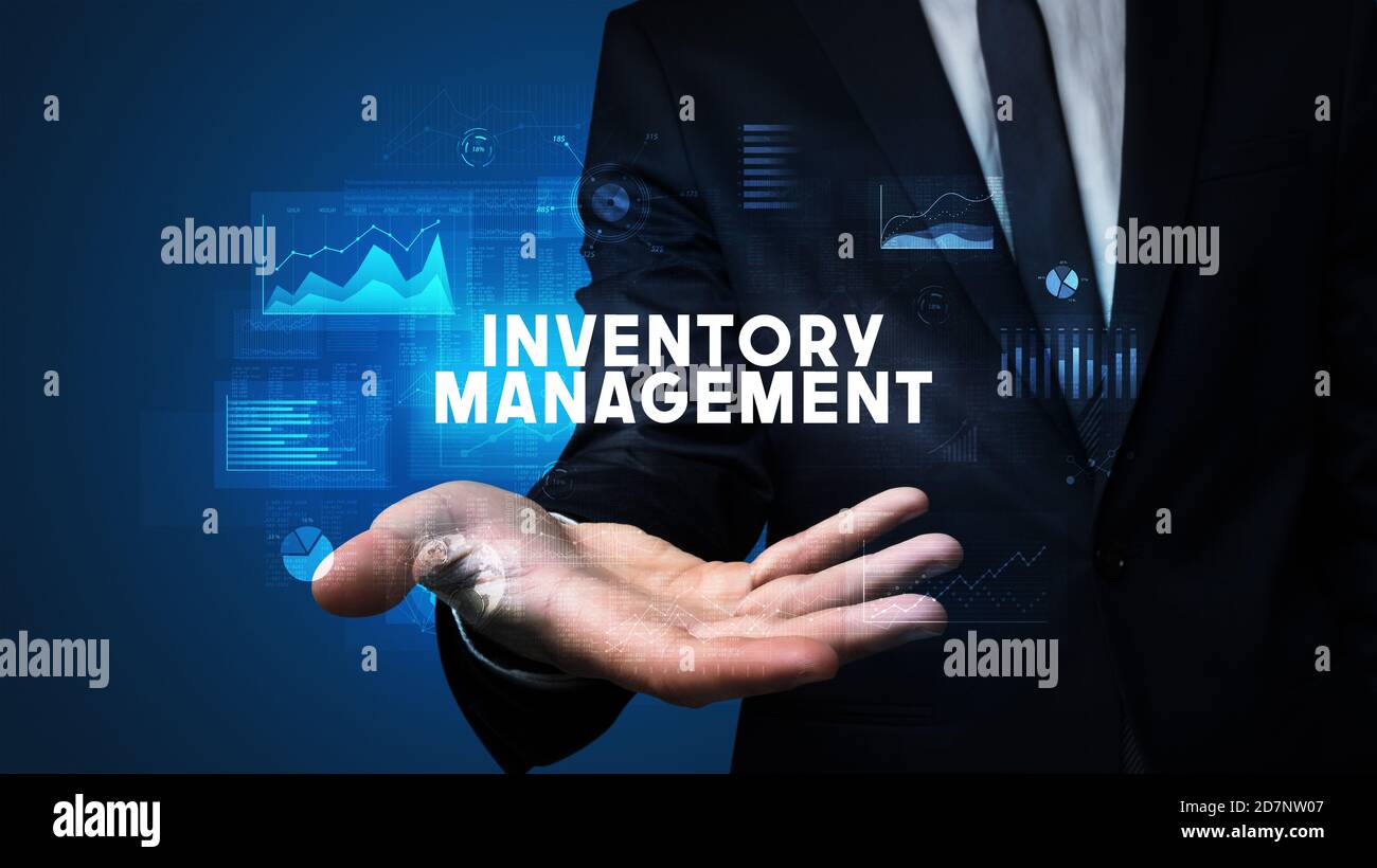 Hand of Businessman holding INVENTORY MANAGEMENT inscription, business ...