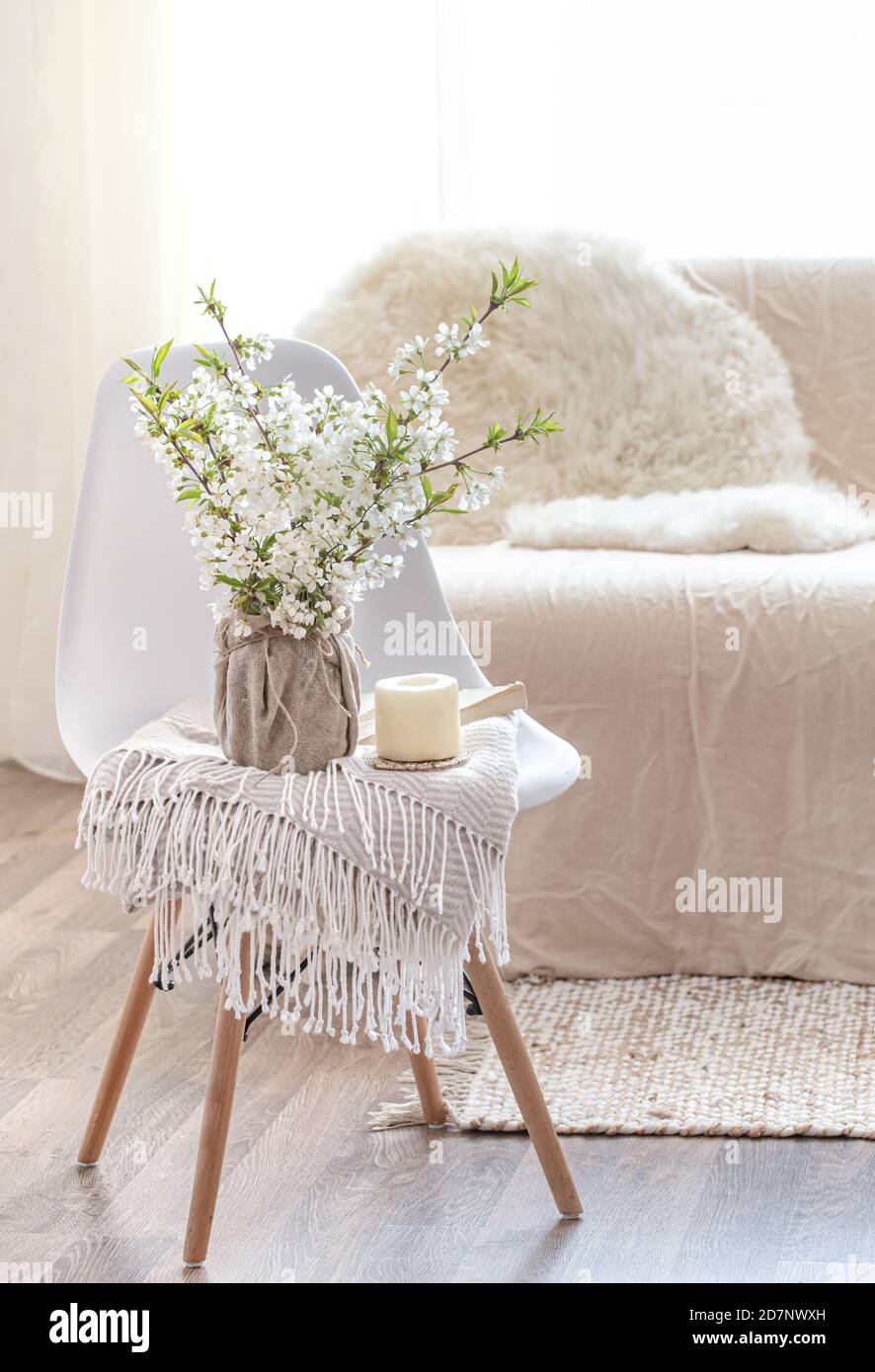 Composition with spring flowers in a cozy living room interior . The ...