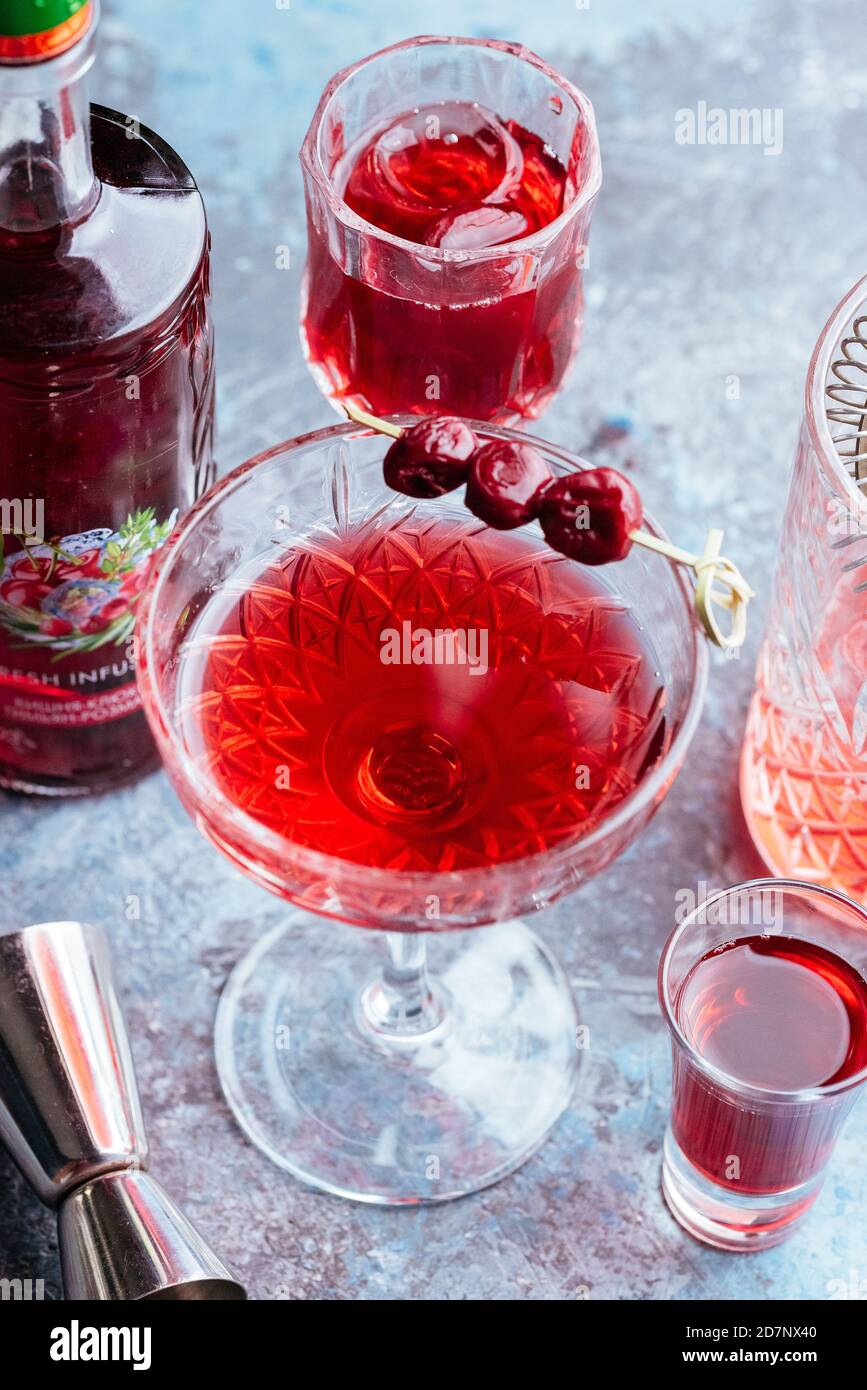 red alcoholic cocktail with various bartender's paraphernalia Stock ...