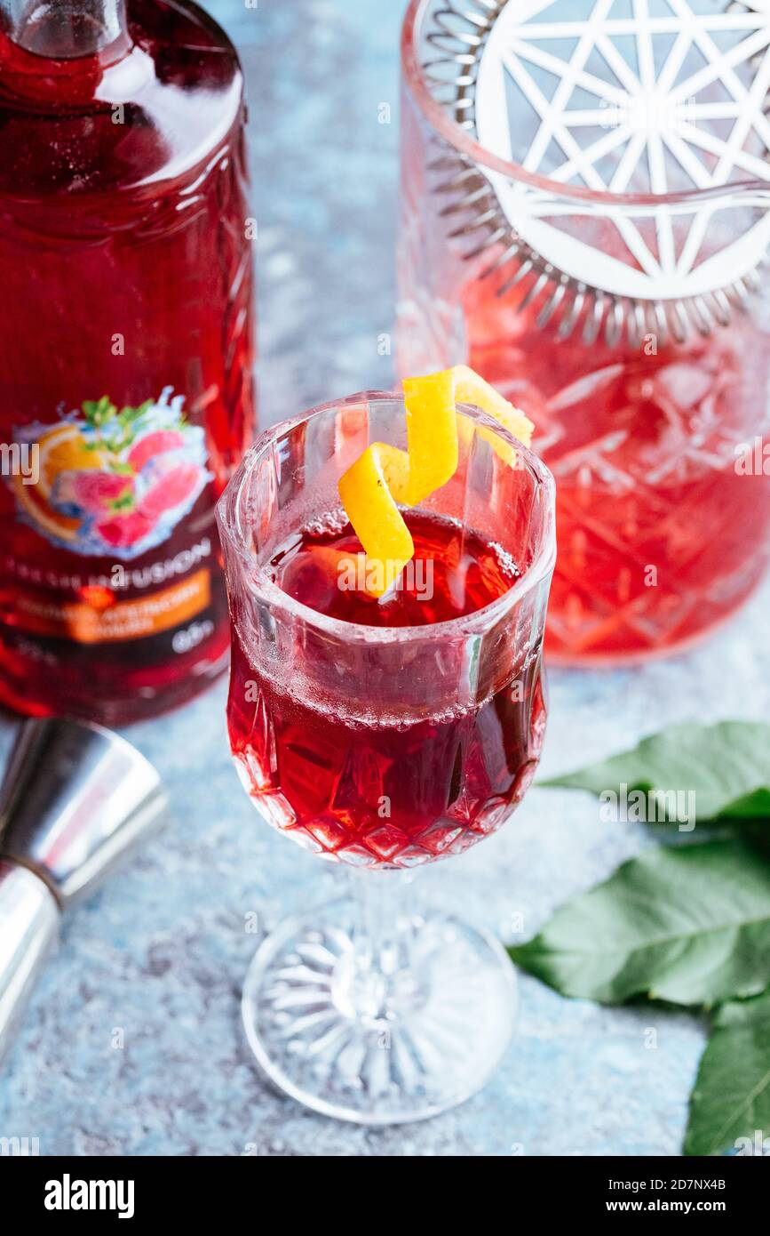 red alcoholic cocktail with various bartender's paraphernalia Stock ...