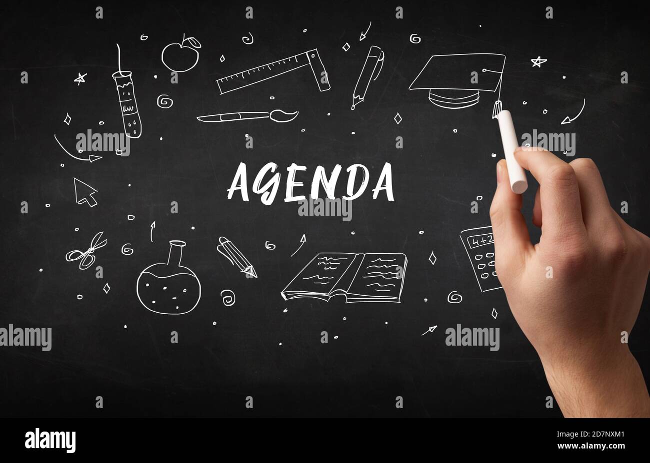 Hand drawing AGENDA inscription with white chalk on blackboard ...