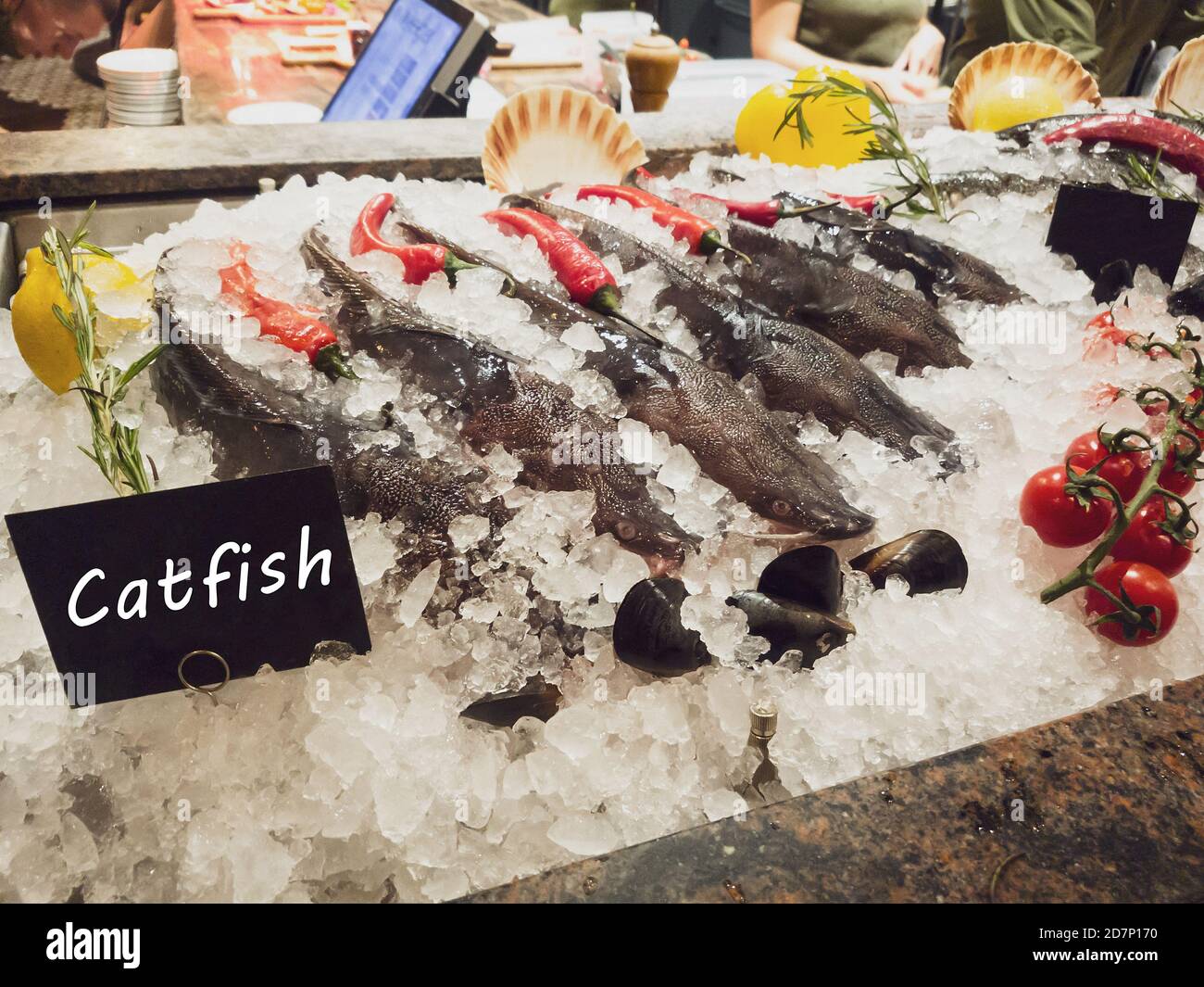 Beautifully laid decorated fresh catfish on ice stall in restaurant ...