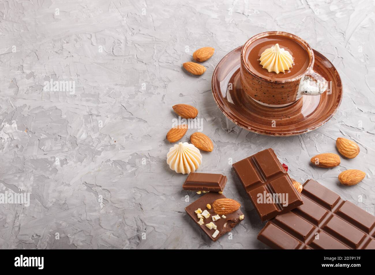 Cup of hot chocolate and pieces of milk chocolate with almonds on a ...