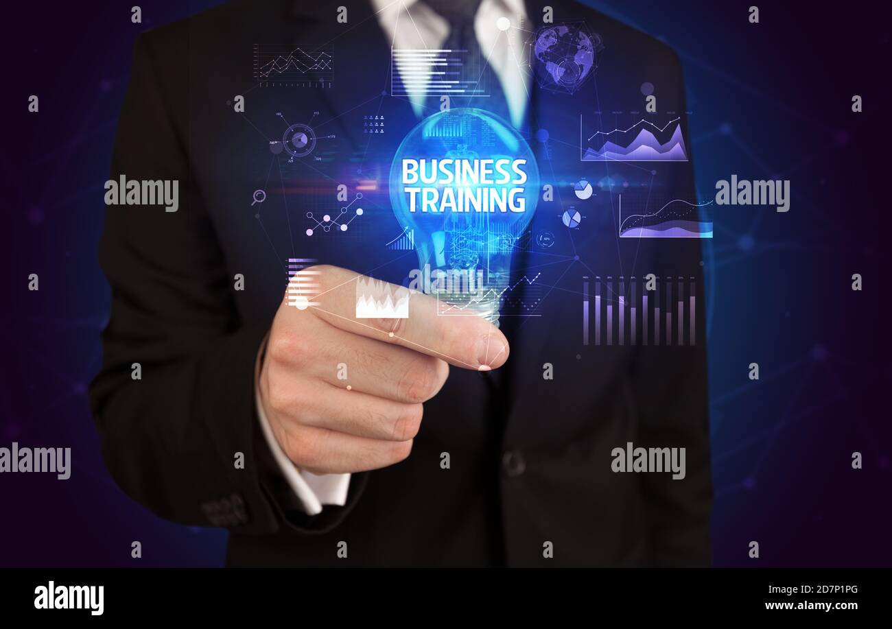 Businessman holding lightbulb with BUSINESS TRAINING inscription, Business idea concept Stock ...