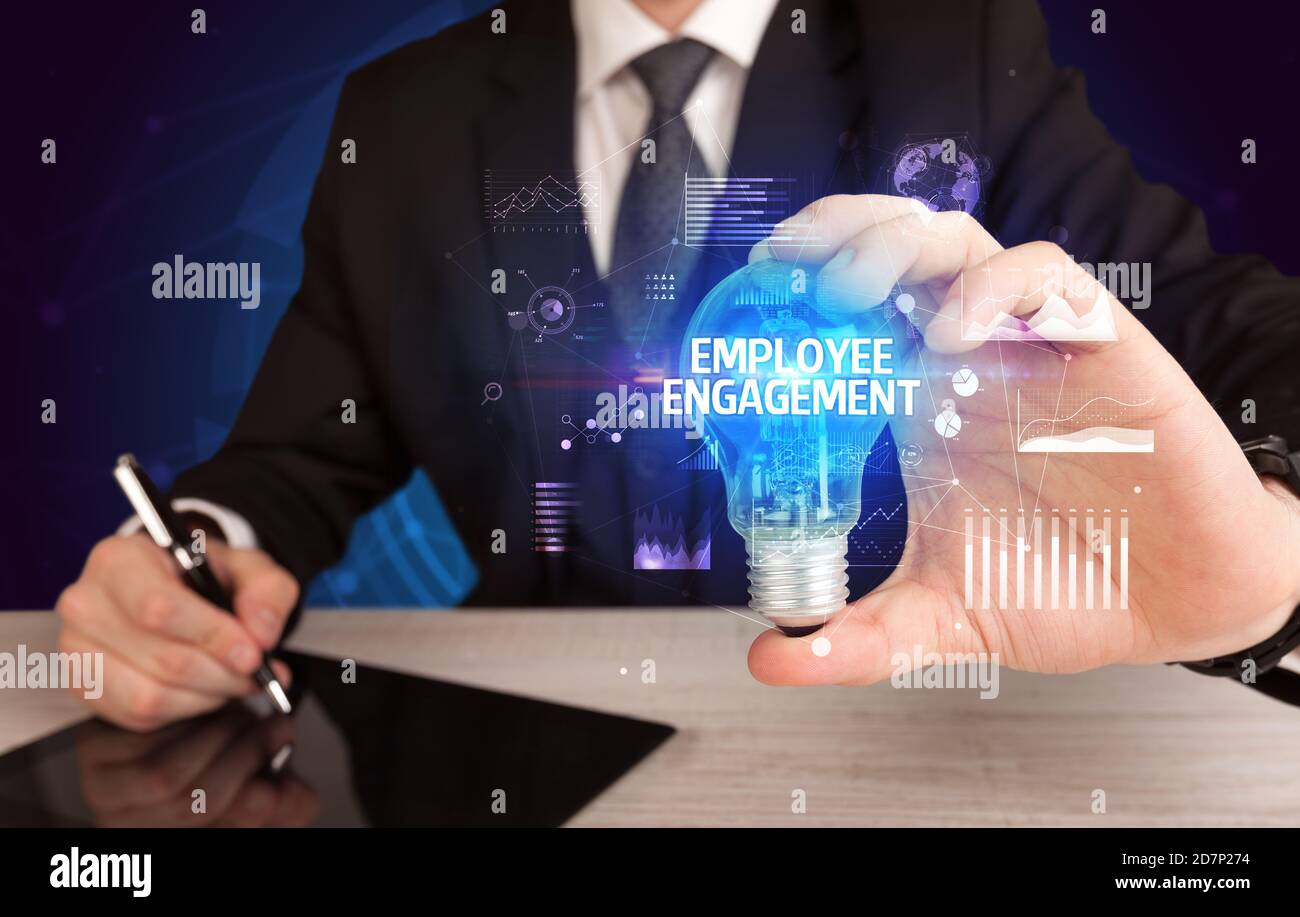Businessman holding lightbulb with EMPLOYEE ENGAGEMENT inscription, Business idea concept Stock ...