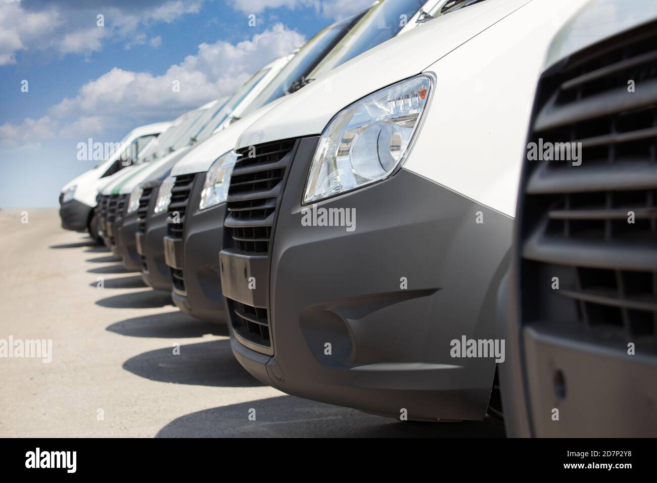 White mini-buses in a row for sale or rent. Close-up. Outside Stock ...