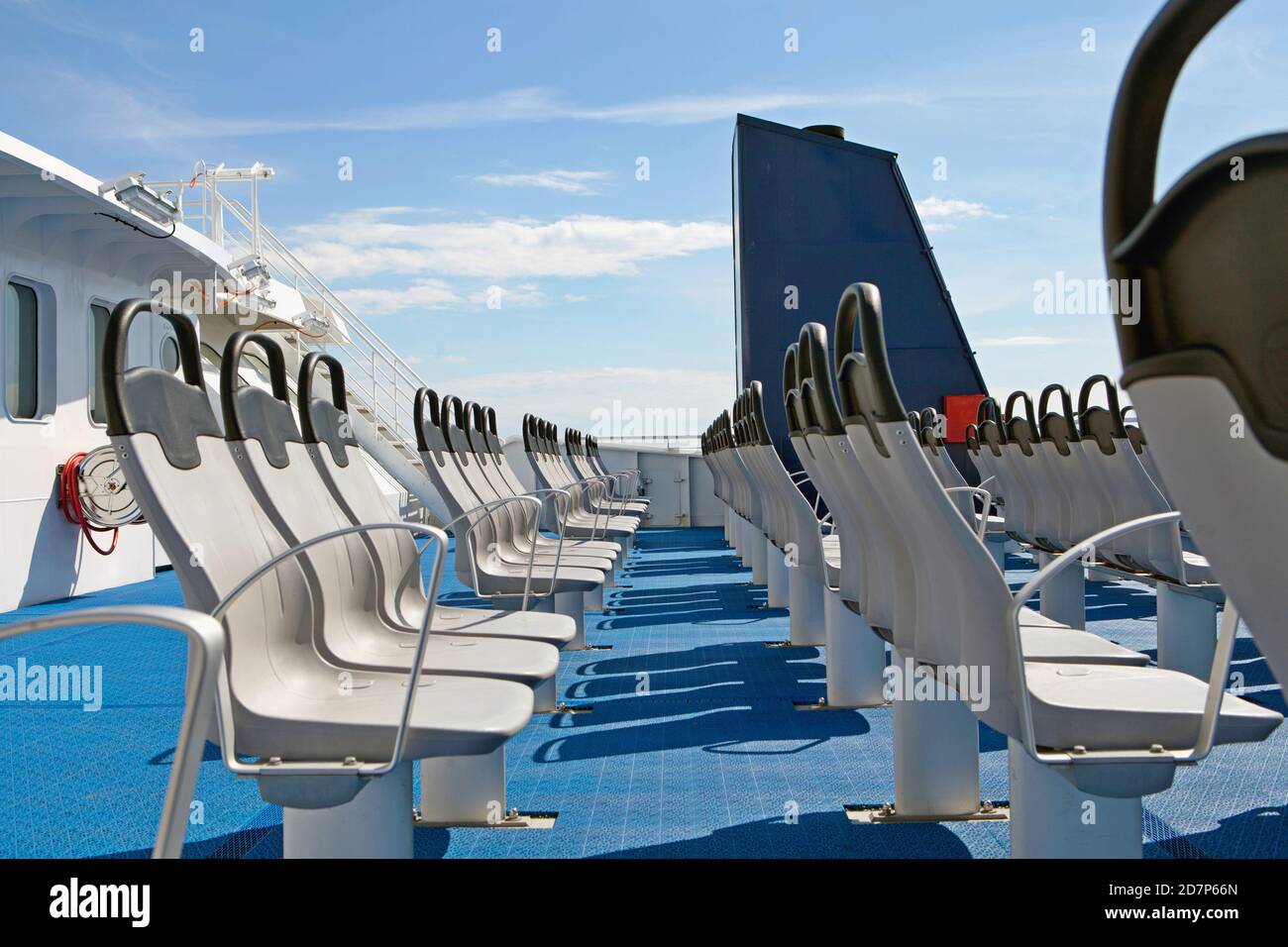 rows of empty plastic seats or chairs on a cruise ship. empty chairs at ...