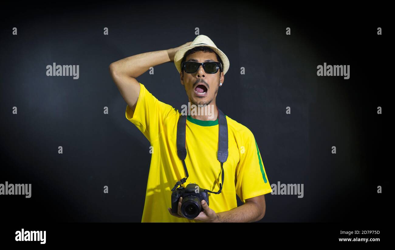 Tourist or fan in yellow uniform with camera and glasses celebrating on ...