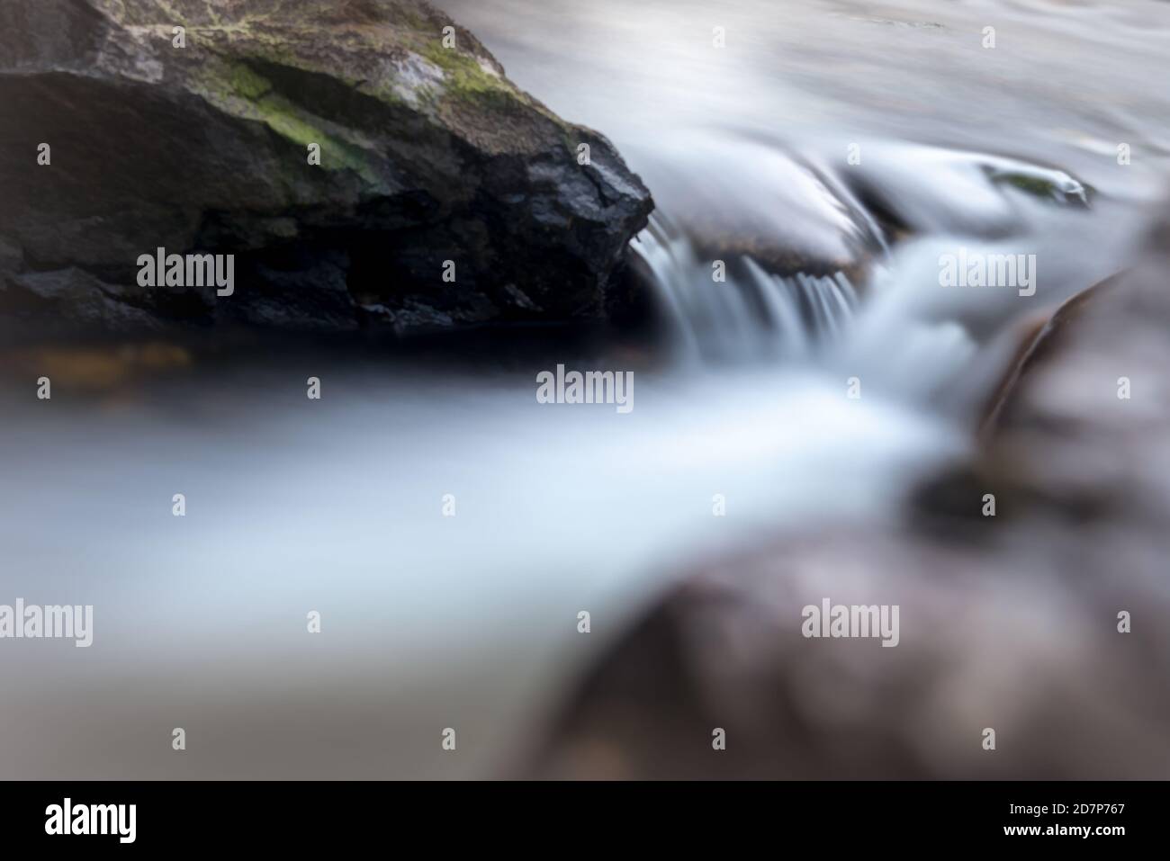Smooth creek water flowing between the rocky canyon in Idaho panhandle ...