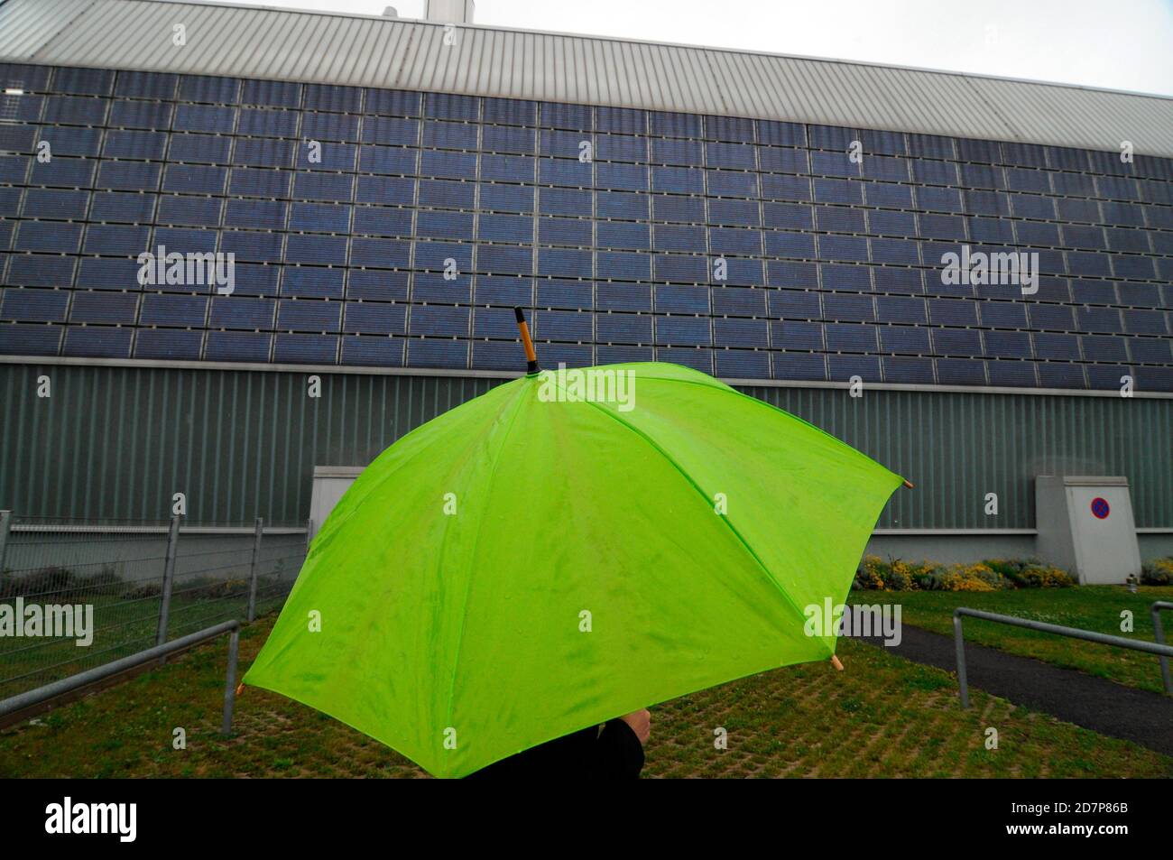 generating energy with solar panels on a building, green umbrella in ...