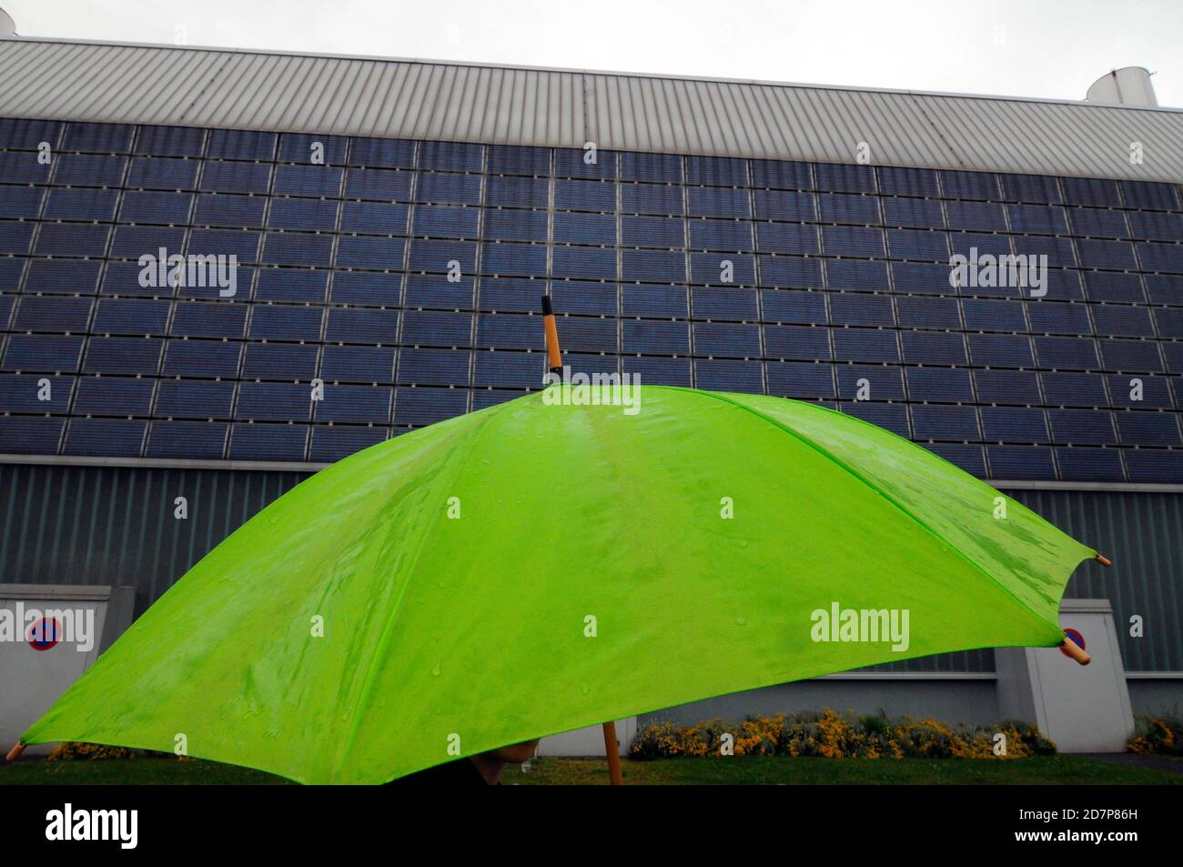 generating energy with solar panels on a building, green umbrella in ...