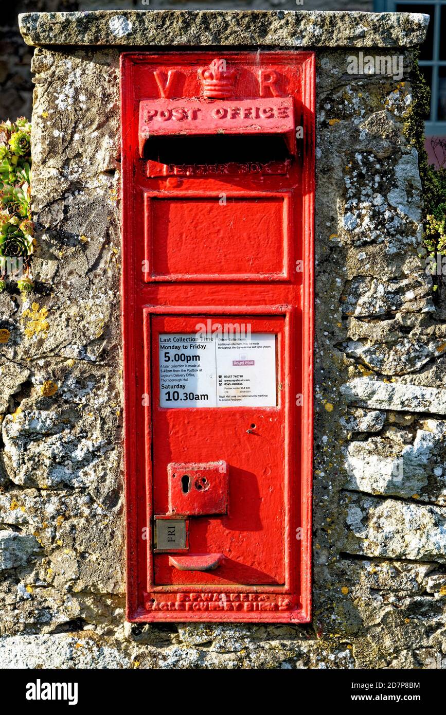 VR red post box, set into the wall in the rural village of Castle ...