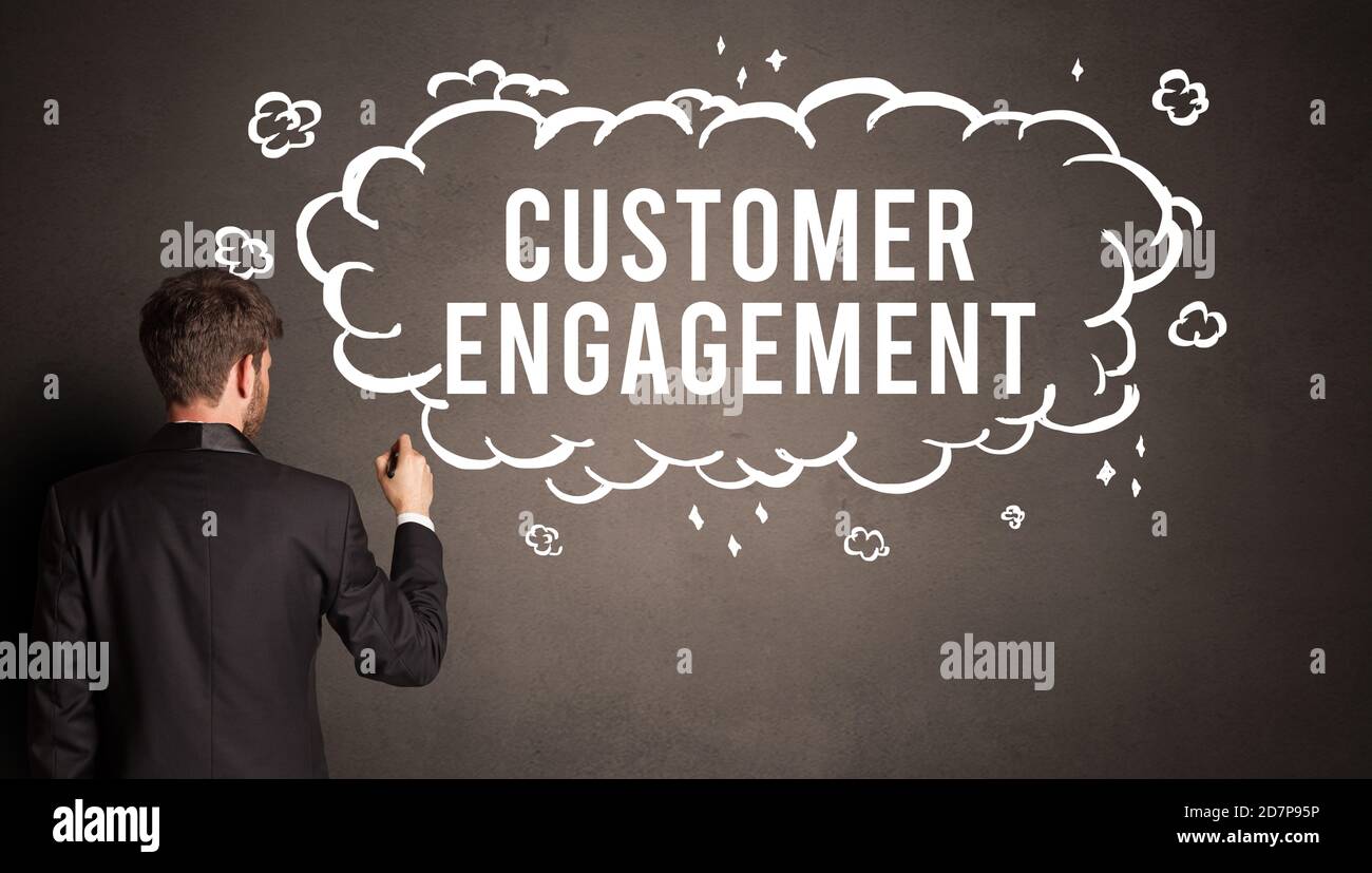 businessman drawing a cloud with CUSTOMER ENGAGEMENT inscription inside ...
