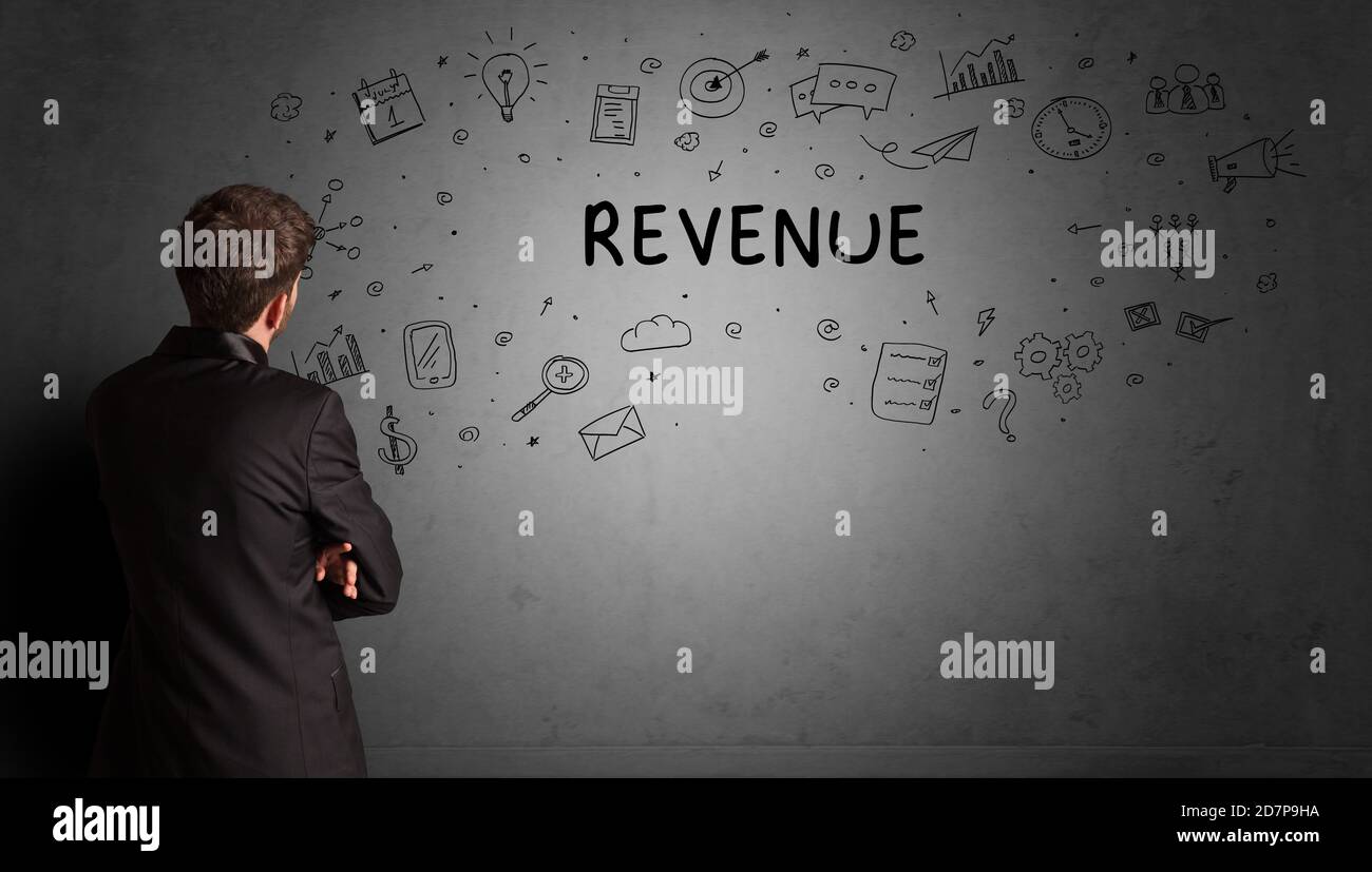 businessman drawing a creative idea sketch with REVENUE inscription ...