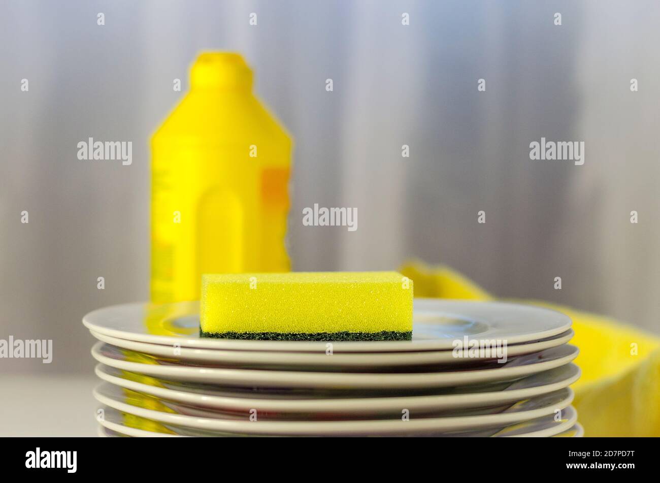 Bottle of dishwashing liquid and stack of utensils isolated on white ...
