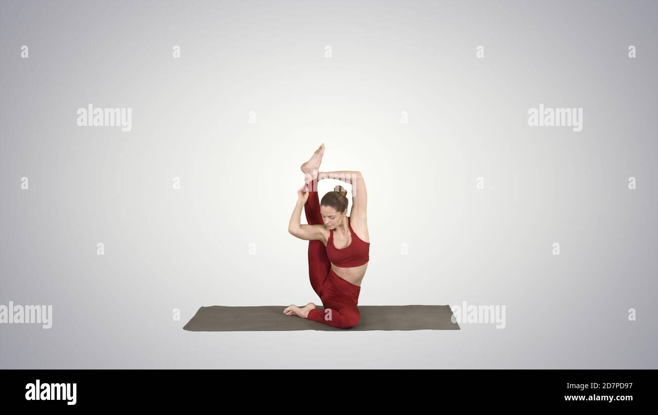 Sporty yogi girl doing fitness practice, stretches, yoga asana P Stock ...