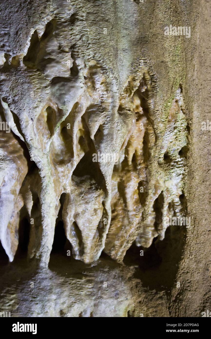 walls inside the cave are covered with stalactites and stalagmites ...