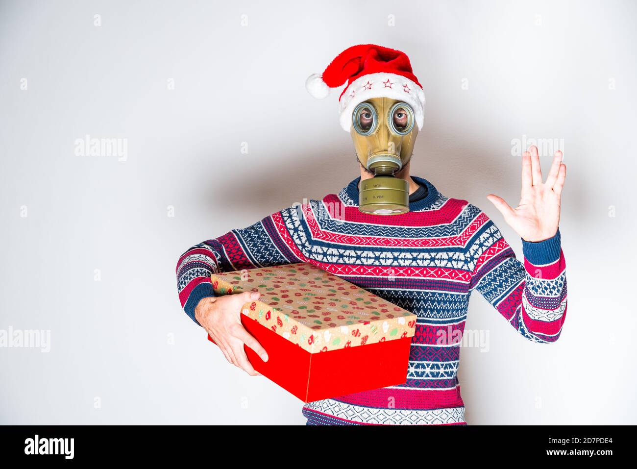 Anonymous person with symbol of Vulcan salutation in Christmas clothes ...