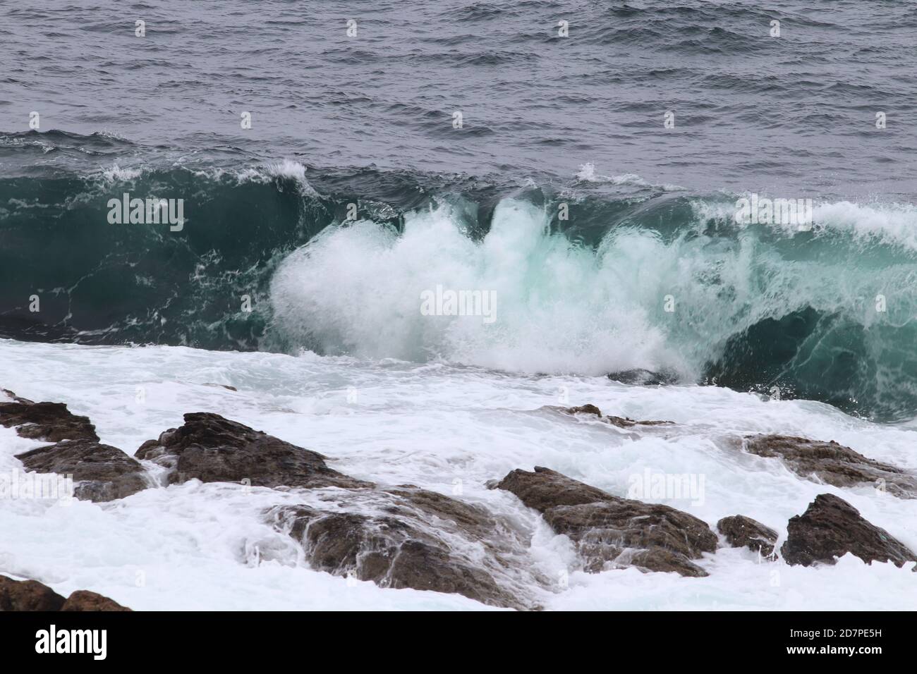 Waves breaking on rocks Stock Photo - Alamy