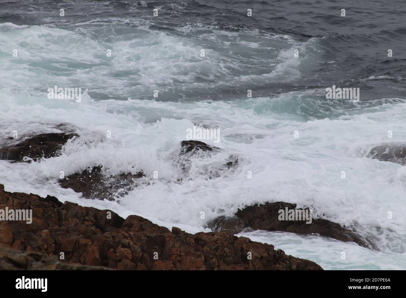 Waves breaking on rocks Stock Photo - Alamy