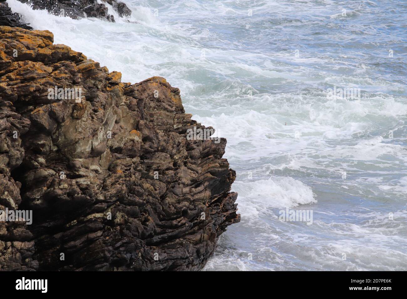 Waves breaking on rocks Stock Photo - Alamy