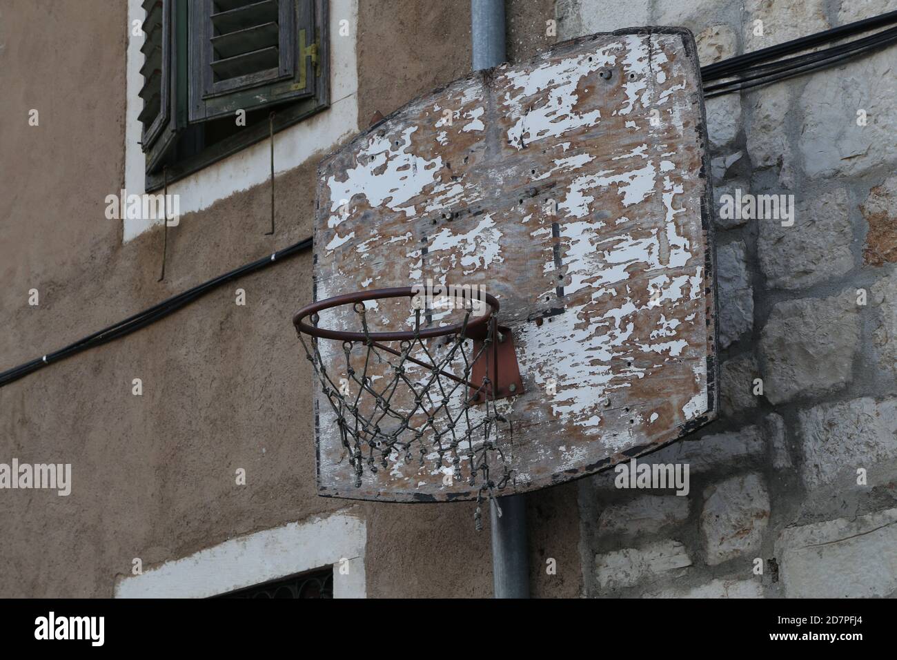 Old basketball ring attached to the wall of the house Stock Photo - Alamy