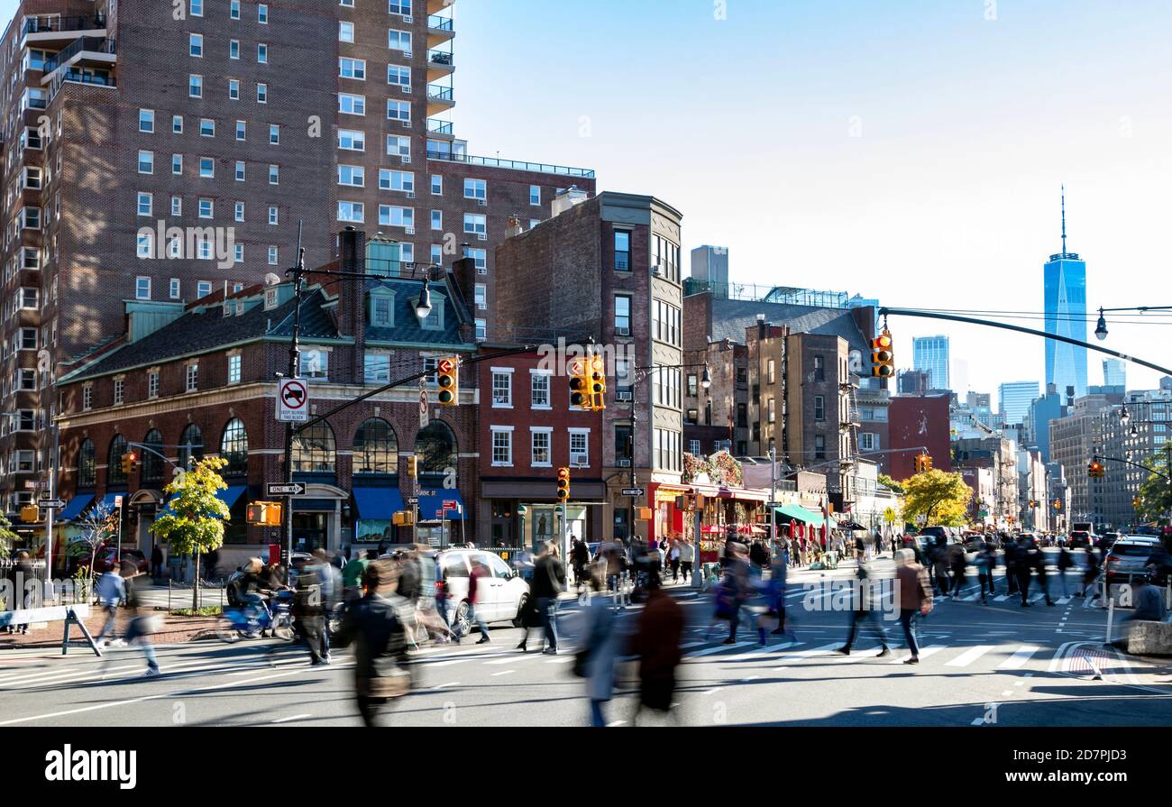 Busy crowds of people walking across the street at 7th Avenue in the ...