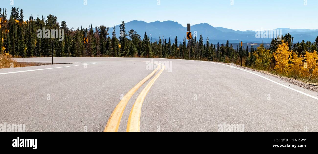 Panoramic view of an empty road winding through a mountain landscape ...