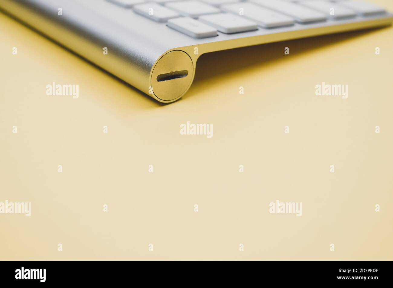 Closeup of a modern and clean keyboard on a yellow surface Stock Photo ...