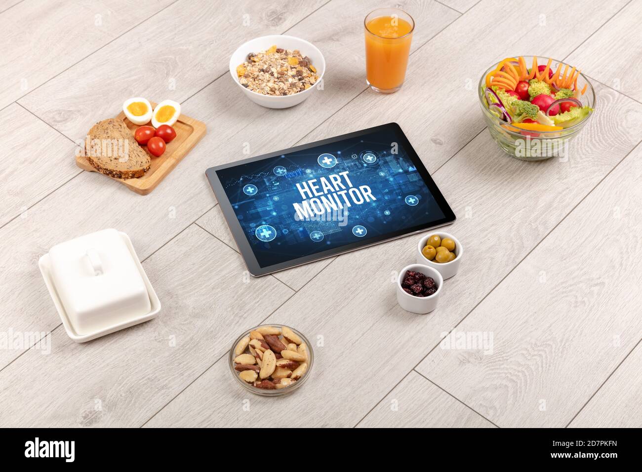 HEART MONITOR concept in tablet pc with healthy food around, top view ...