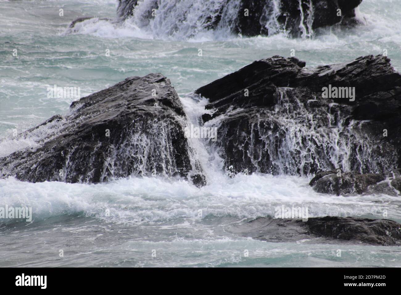 Waves breaking on rocks Stock Photo - Alamy