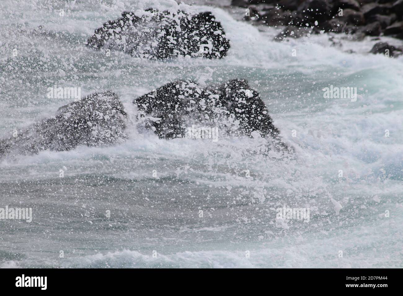 Waves breaking on rocks Stock Photo - Alamy