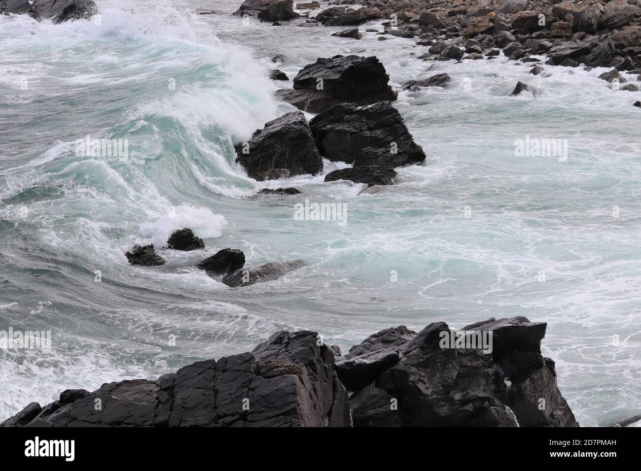 Waves breaking on rocks Stock Photo - Alamy