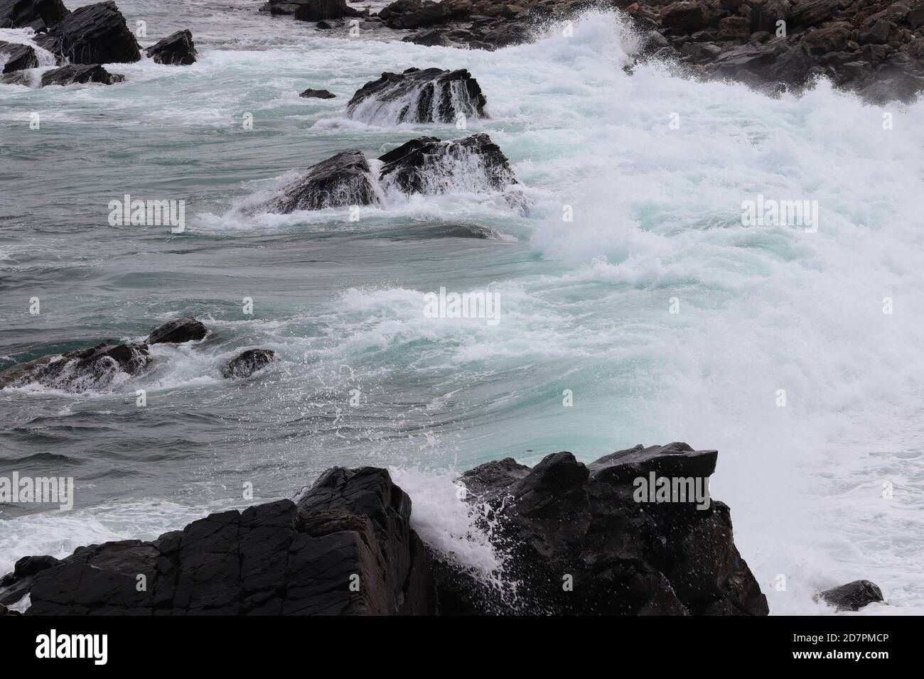 Waves breaking on rocks Stock Photo - Alamy