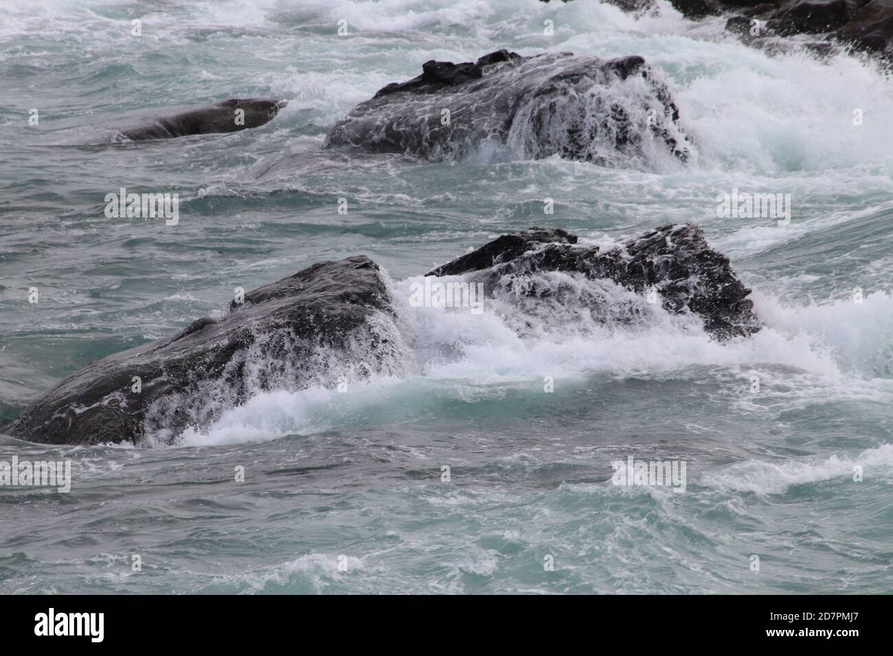 Waves breaking on rocks Stock Photo - Alamy