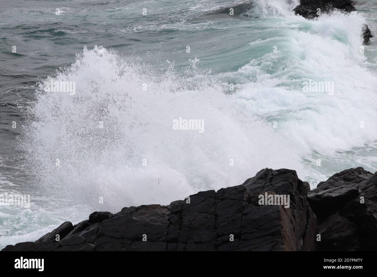 Waves breaking on rocks Stock Photo - Alamy