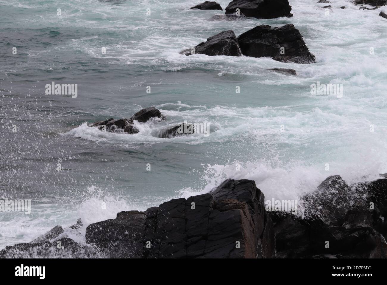 Waves breaking on rocks Stock Photo - Alamy