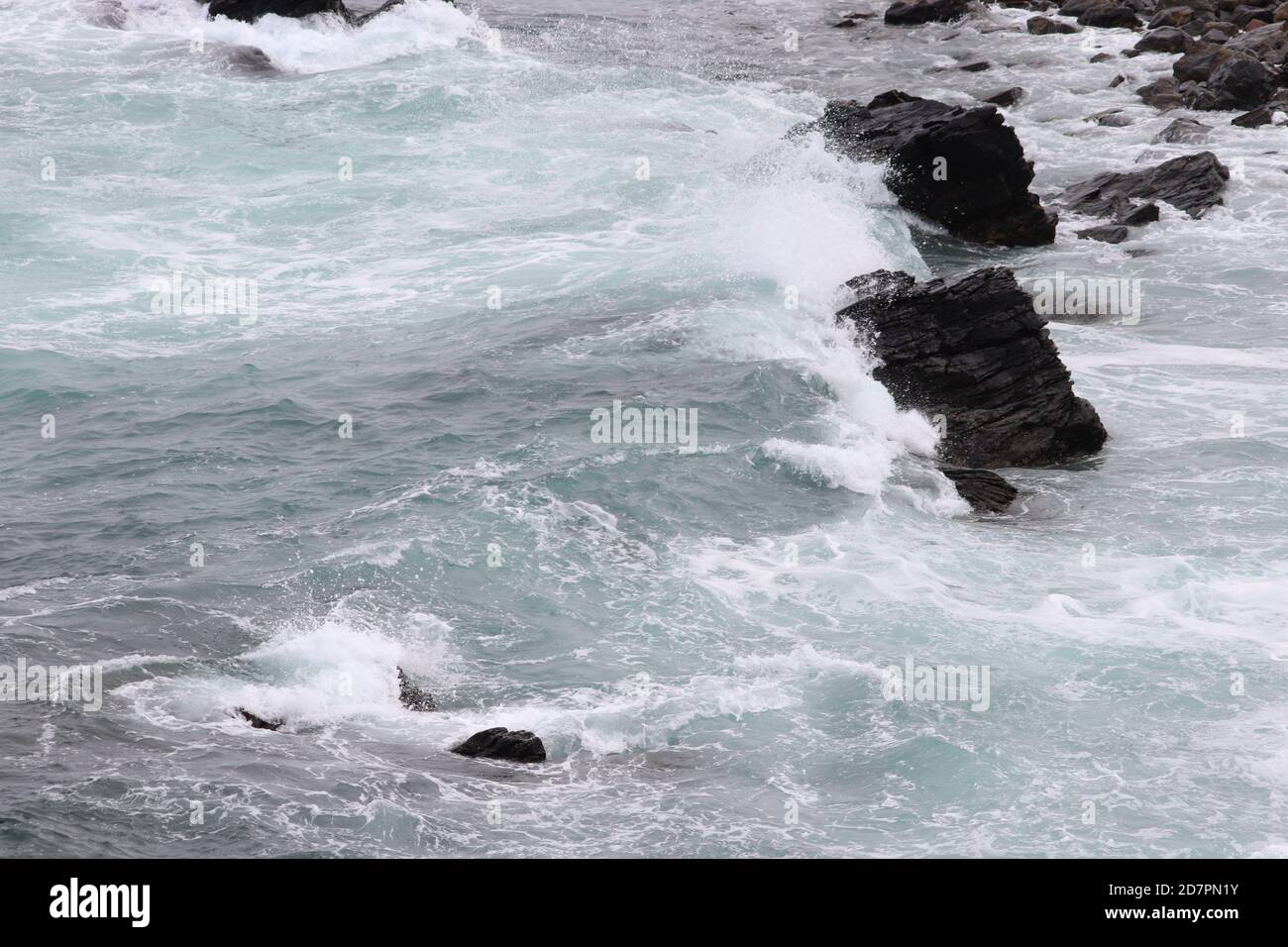 Waves breaking on rocks Stock Photo - Alamy