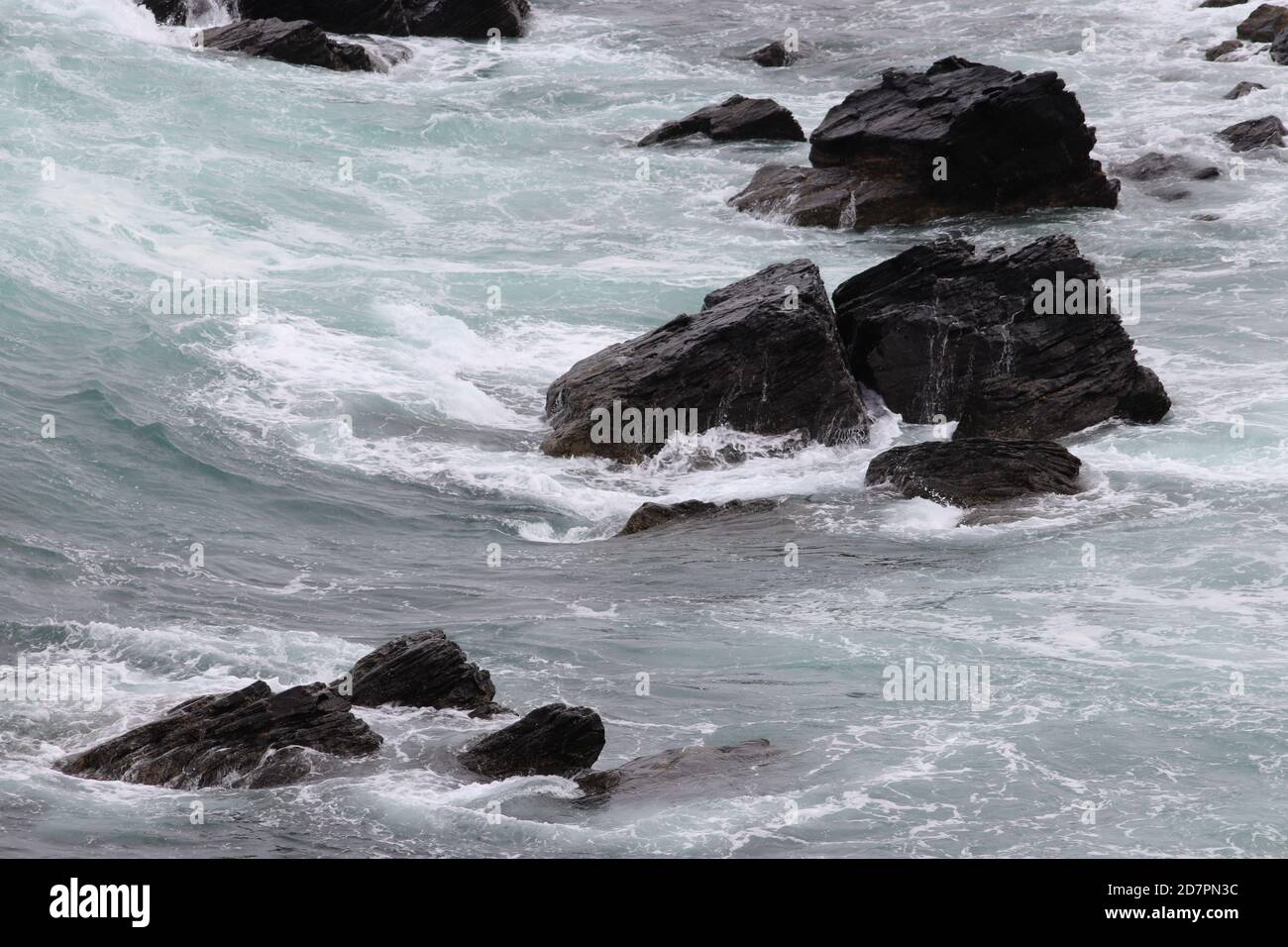 Waves breaking on rocks Stock Photo - Alamy