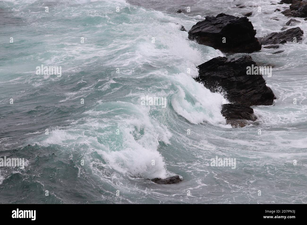 Waves breaking on rocks Stock Photo - Alamy