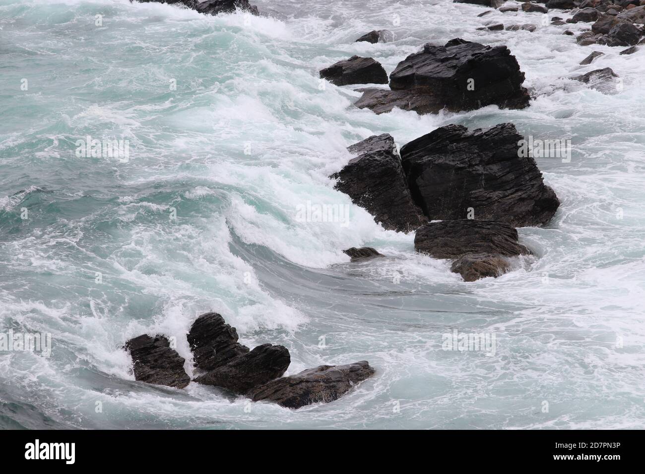 Waves breaking on rocks Stock Photo - Alamy