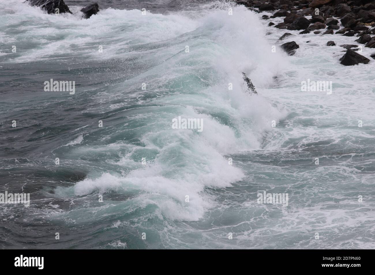 Waves breaking on rocks Stock Photo - Alamy
