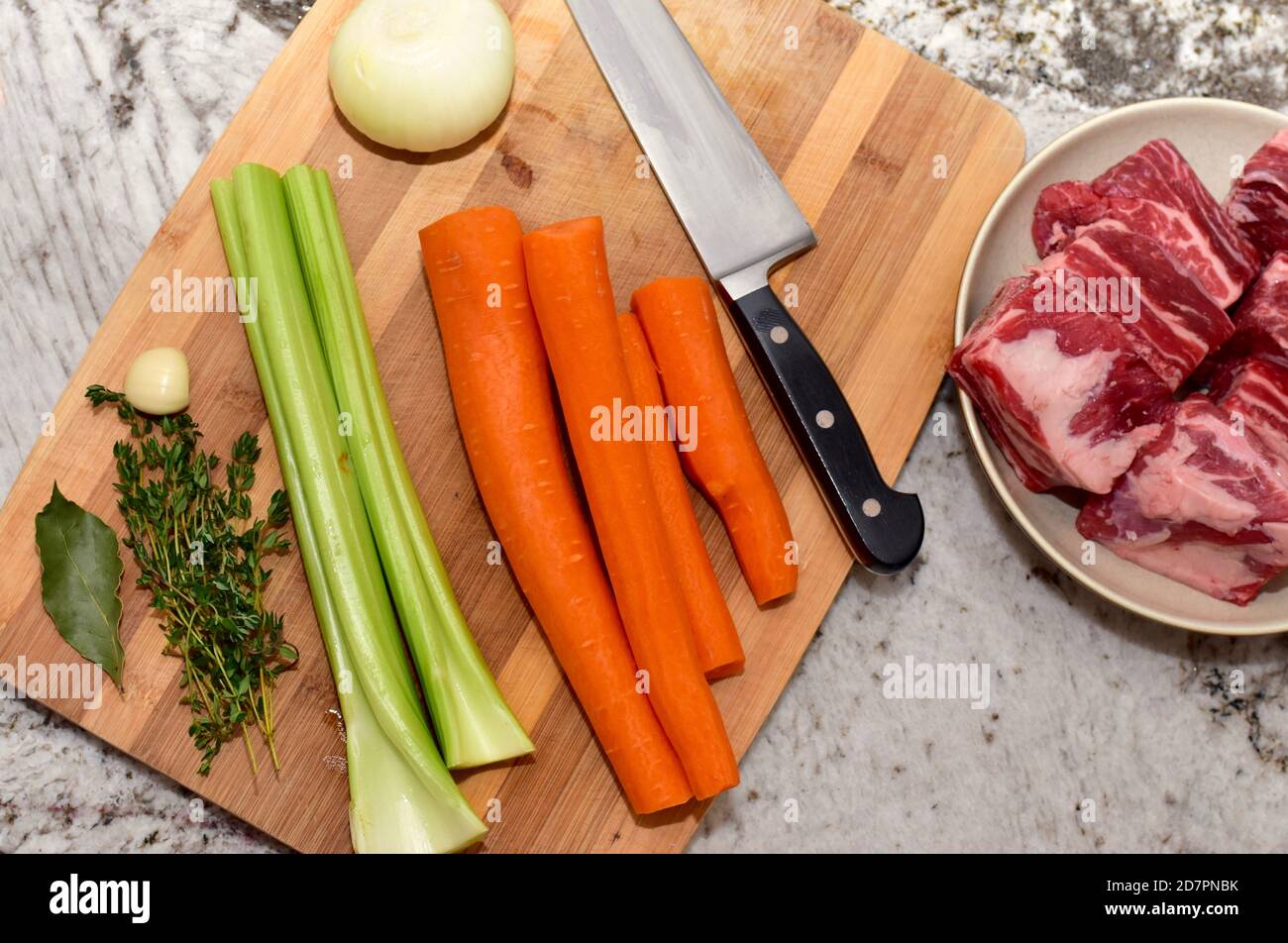Fresh whole food ingredients ready for preparing braised simmering beef ...
