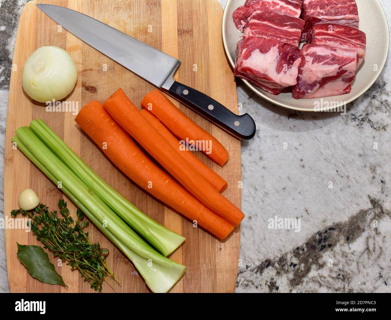 Fresh whole food ingredients ready for preparing braised simmering beef ...
