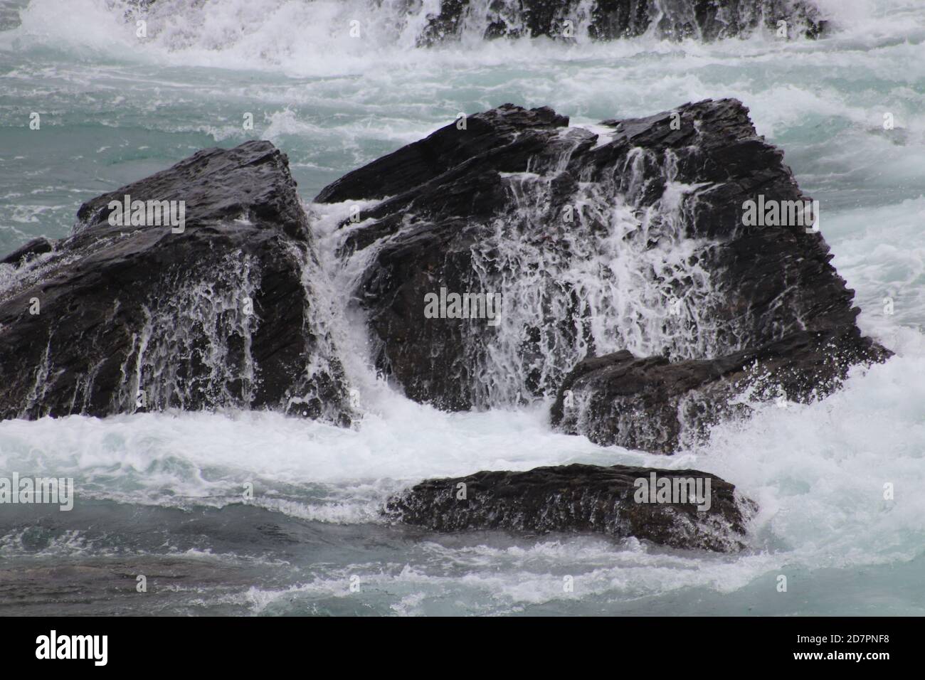 Waves breaking on rocks Stock Photo - Alamy