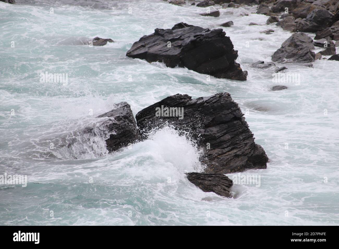 Waves breaking on rocks Stock Photo - Alamy