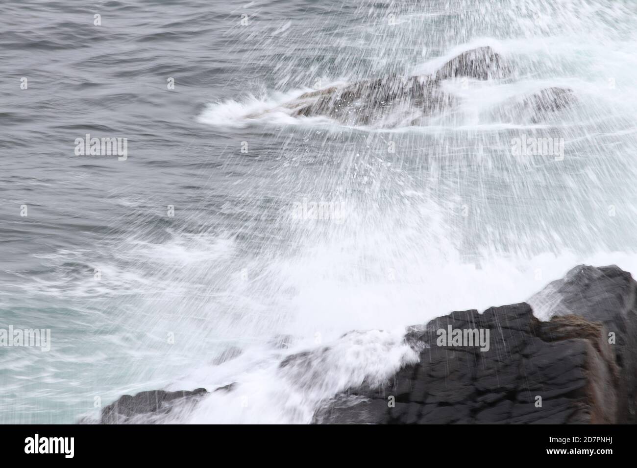 Waves breaking on rocks Stock Photo - Alamy