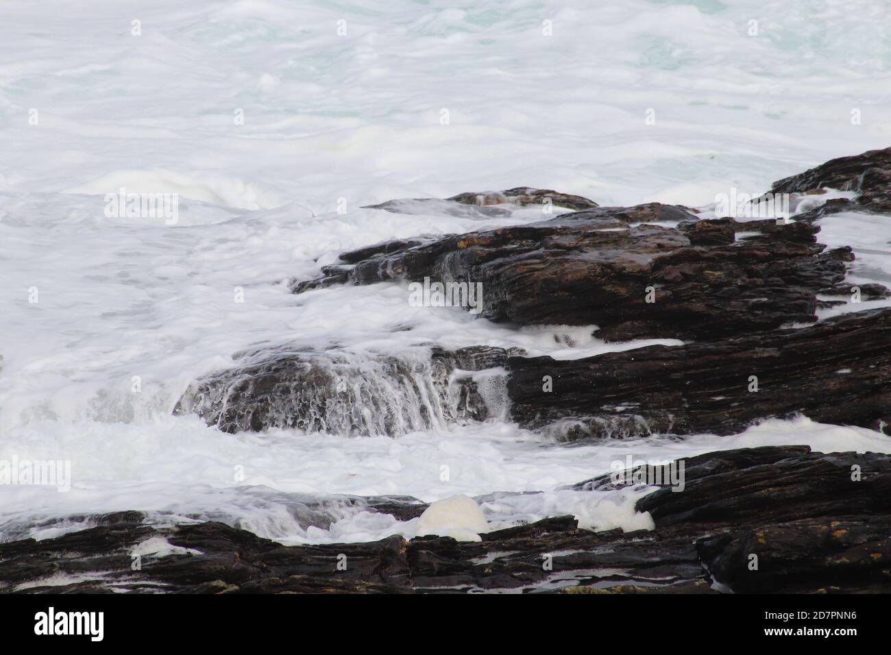 Waves breaking on rocks Stock Photo - Alamy